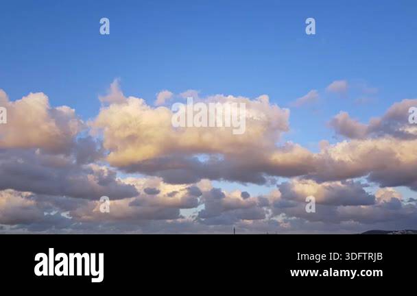 A dramatic sky dominates the upper half of the frame where rugged ...