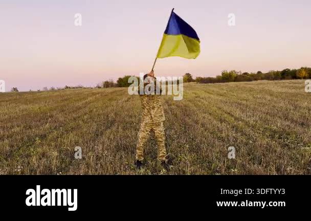 Male military lifted flag of Ukraine in honor of victory against ...