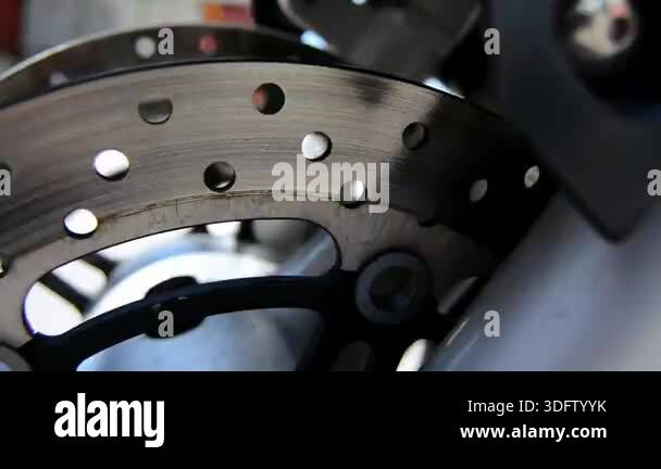 Close-up of a motorcycle brake disc with visible holes Stock Video ...