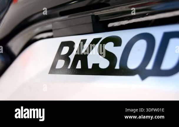 Close-up of a black and white logo with the text 'BKSQD' on a smooth ...