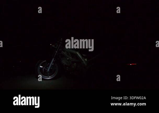 A motorcycle in low light with a dark background Stock Video Footage ...