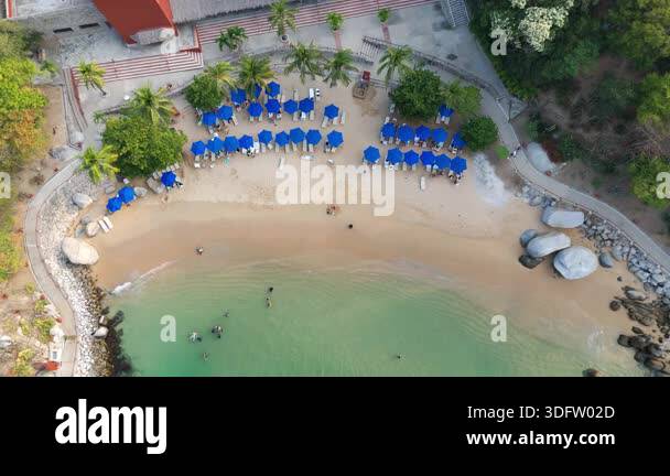 High-angle drone shot of a sunny, crescent-shaped resort beach ...