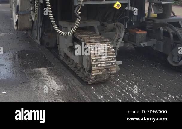 Close up of tracked construction machine, asphalt paver or road milling ...