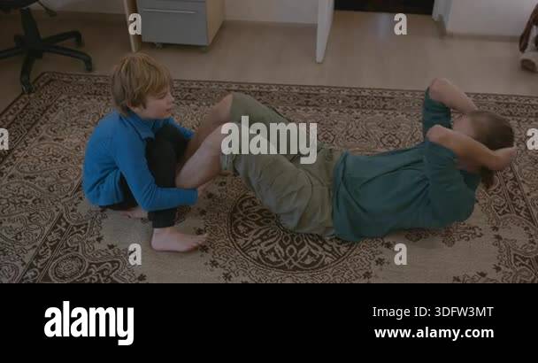 Man Does Exercise Workout with Kid at Home. 4K 10-bit Stock Video ...