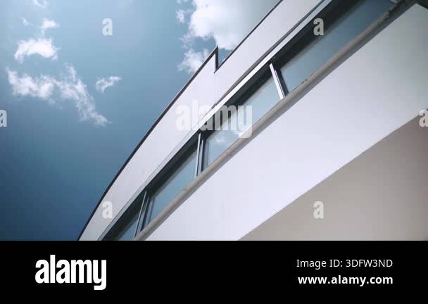 Modern Curved White Building Facade with Panoramic Windows Against Blue ...