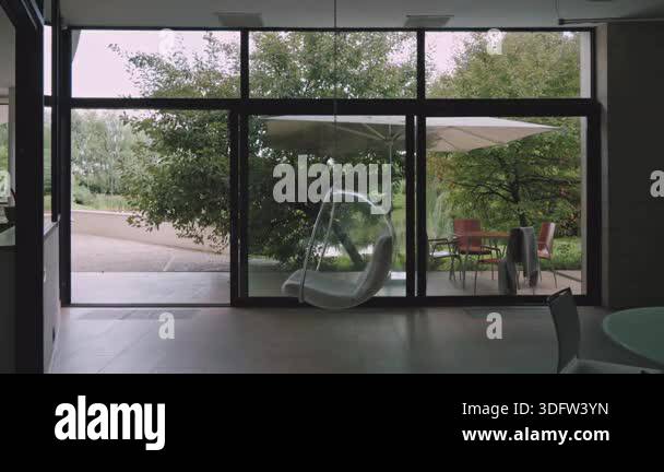 Static Shot of Modern Minimalist Interior with Hanging Chair Gently ...