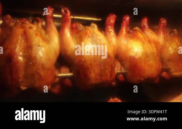 Chickens roasting. Close up whole chickens roasting on rotating ...