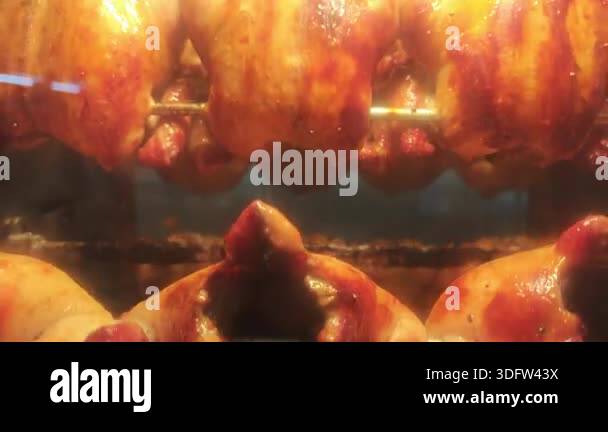 Chickens roasting. Close up whole chickens roasting on rotating ...
