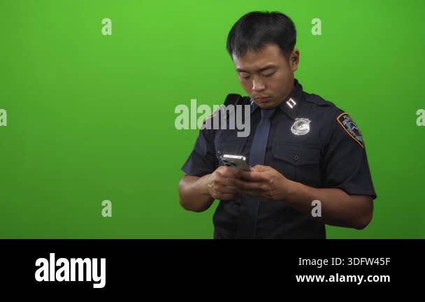 Young chinese policeman holds smartphone while checking messages in ...