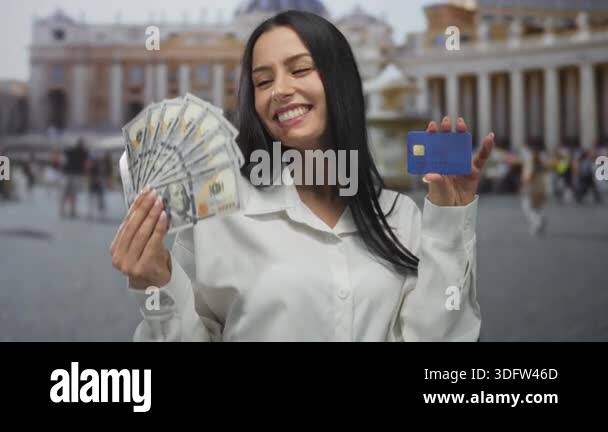 Woman smiling at vatican square holding us dollars and credit card ...