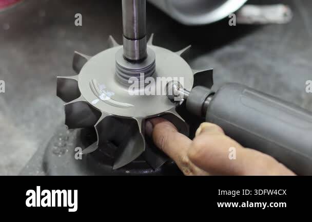 Close-up of a technician's hands using a professional rotary burr die ...