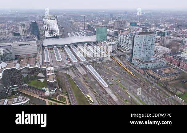 Aerial modern city railway station with train arriving among urban ...