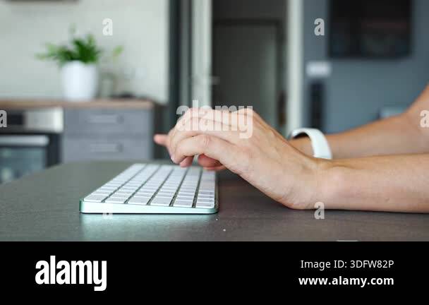 Close up of woman hands typing on wireless keyboard on desk in home ...