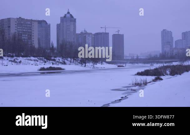 Heavy snow falling over a residential district in Kyiv, Ukraine, with a ...