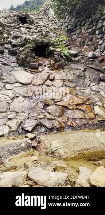 Ancient stone dam structure in forest valley Stock Video Footage - Alamy