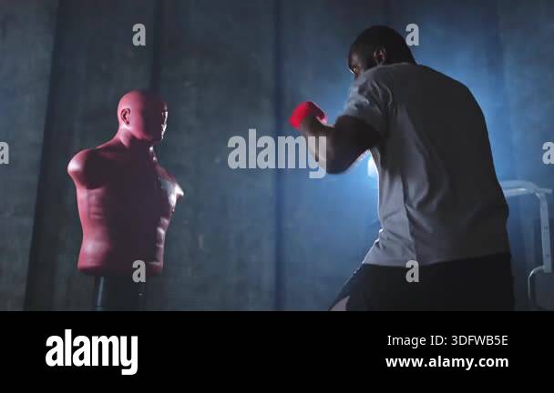 Fitness workout in gym. Strong African man fighter training punches ...