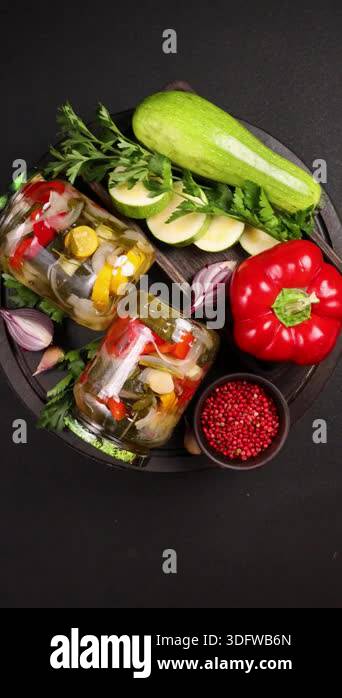 Fermented foods in glass jars rotating with fresh vegetables like ...