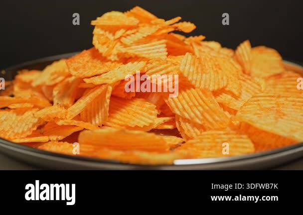 Crispy golden potato chips are falling slow motion. Fast food and junk ...