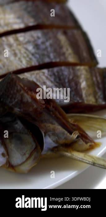 An eye-level close-up reveals a dry fish, expertly cut and thoughtfully ...