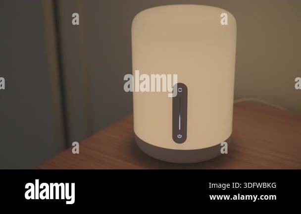 Smart lamp standing on a table smoothly changing colors Stock Video ...