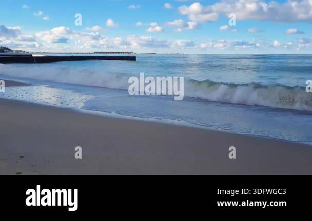 Low angle shot of clear turquoise water waves breaking near coastline ...