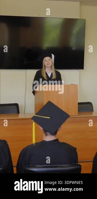 A young woman stands at the lectern and delivers a graduation speech to ...