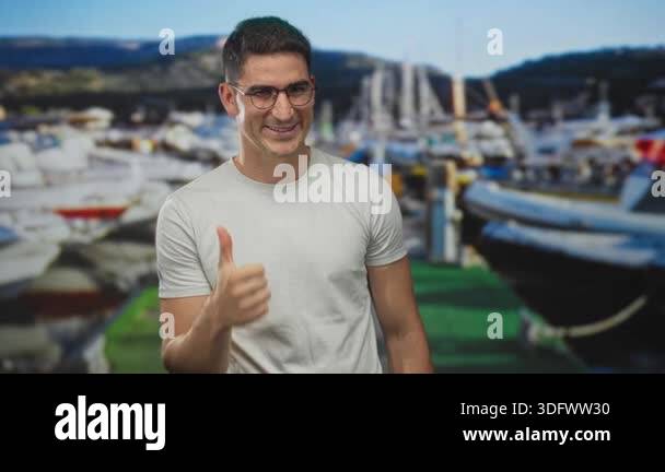 Man pointing finger to chest and smiling while wearing glasses and a ...