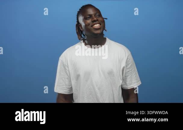 Man smiling, showing teeth, wearing white tshirt and dreadlocks ...
