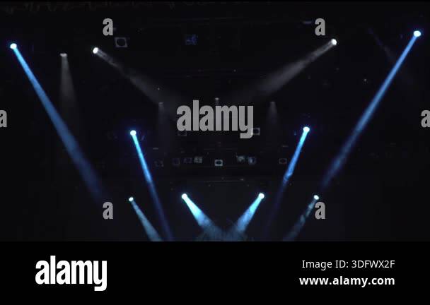Dramatic concert stage lighting with blue spotlights projecting beams ...