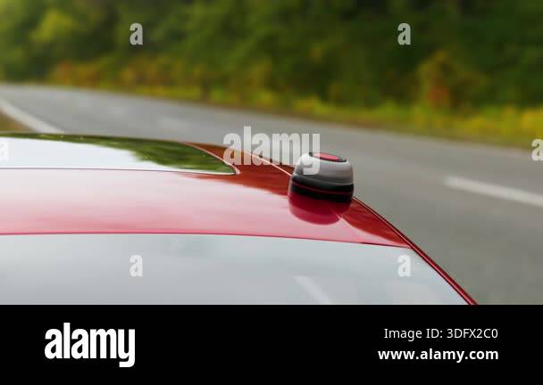 Beacon V16 amber emergency light flashing on a red car roadside, with a ...