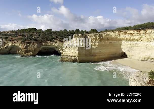 Golden rock cliffs at the coastline of the Atlantic Ocean with beach ...