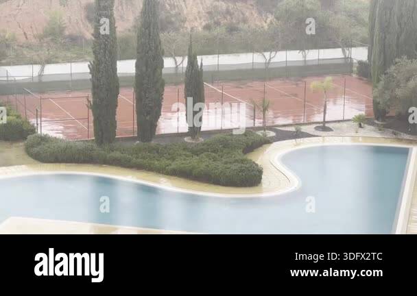 View from window on lounge area near inground swimming pool with deck ...