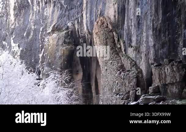 Rock wall. Prohodna Cave in Bulgaria. Entrance or exit from the cave ...