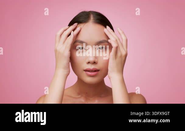 A beautiful young woman engages in a pampering skin care routine. She ...