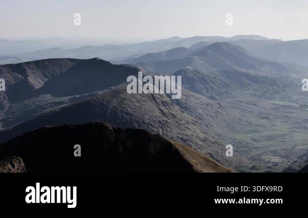 A panoramic view looking out across mountains, valley, and landscape ...