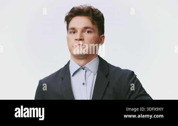 A young, handsome man poses confidently in a sleek outfit. The backdrop ...