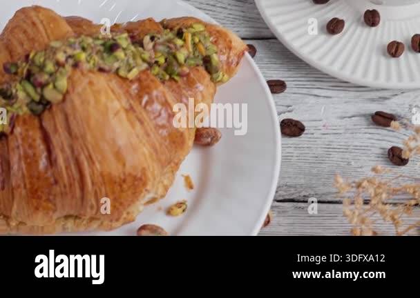 Close-up shot from video showing pistachio croissant, pistachio cake ...