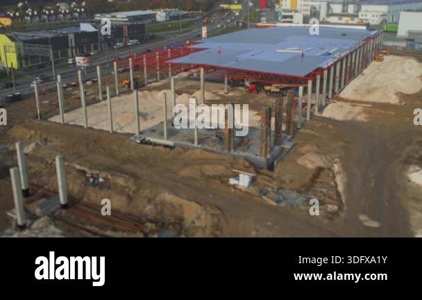 concrete foundations and red column grid taking shape, excavation ...