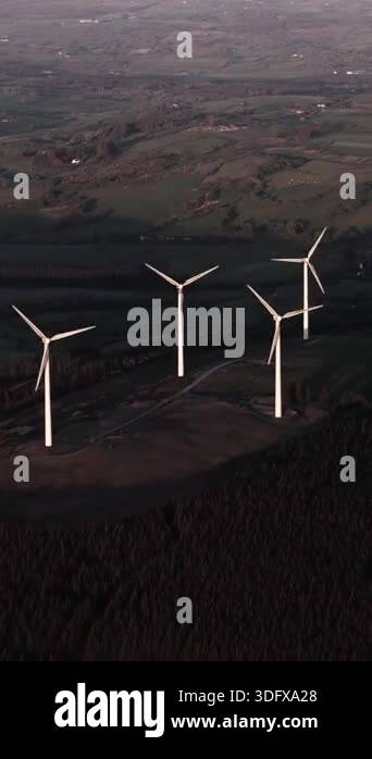 Wind farm at dawn in Ireland, generating clean renewable energy on a ...
