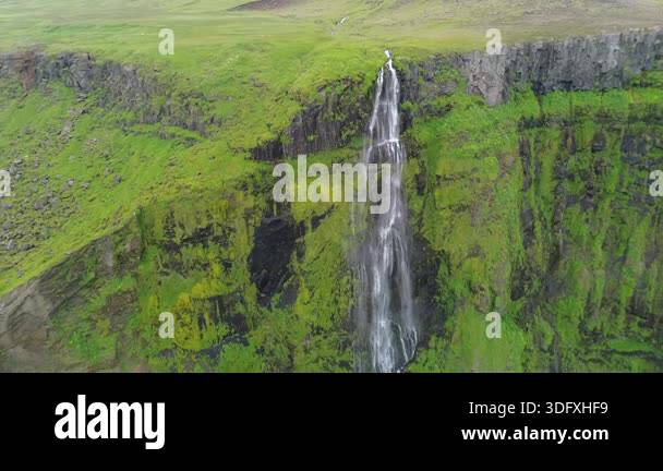 Waterfall falling from the high cliff in Iceland from drone Stock Video ...