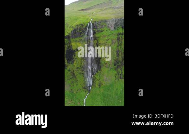 Waterfall falling from the high cliff in Iceland from drone Stock Video ...