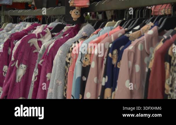 Hanging row of soft homewear in pastel and bright colors with teddy ...