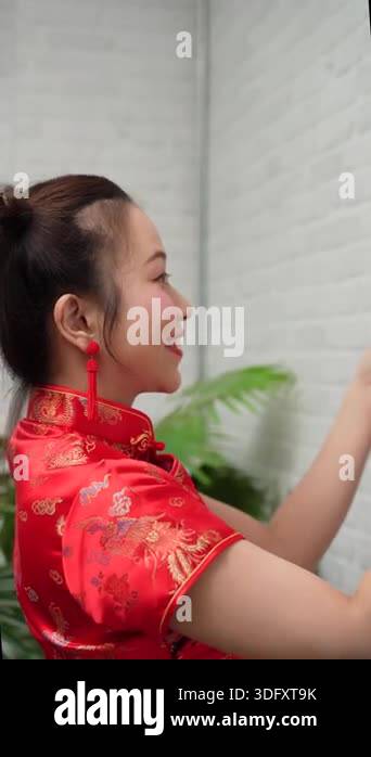 Happy young Asian woman wearing traditional red cheongsam dress ...