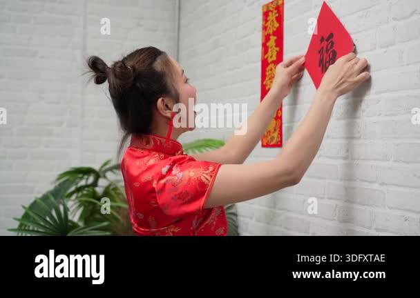 Happy young Asian woman wearing traditional red cheongsam dress ...