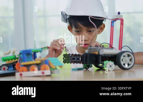 Asian boy engineer working on robotics project in a STEM education ...