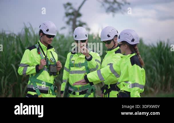 Engineers working on site in electricity substation. Technician wearing ...