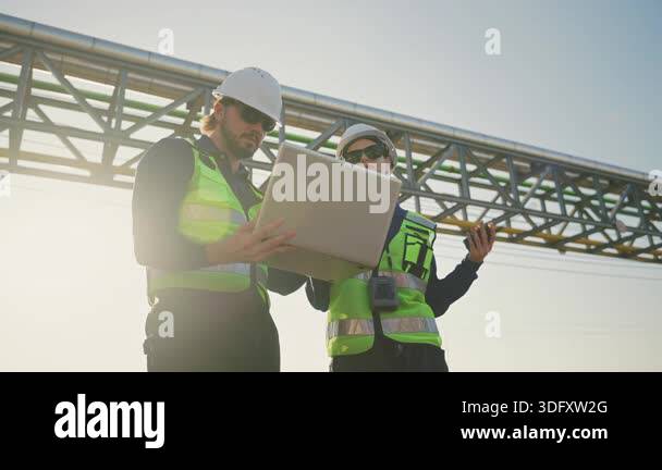 Industrial Engineers Inspecting Construction Site with Laptop ...