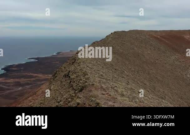 Aerial drone footage of the narrow ridge leading to the peak of Montaa ...