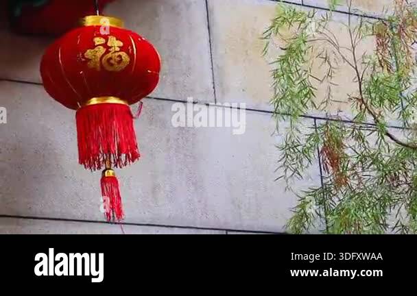Authentic outdoor video of a red Chinese lantern with silk tassels ...