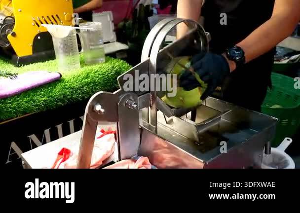 High action video of an industrial coconut cutting machine at a night ...